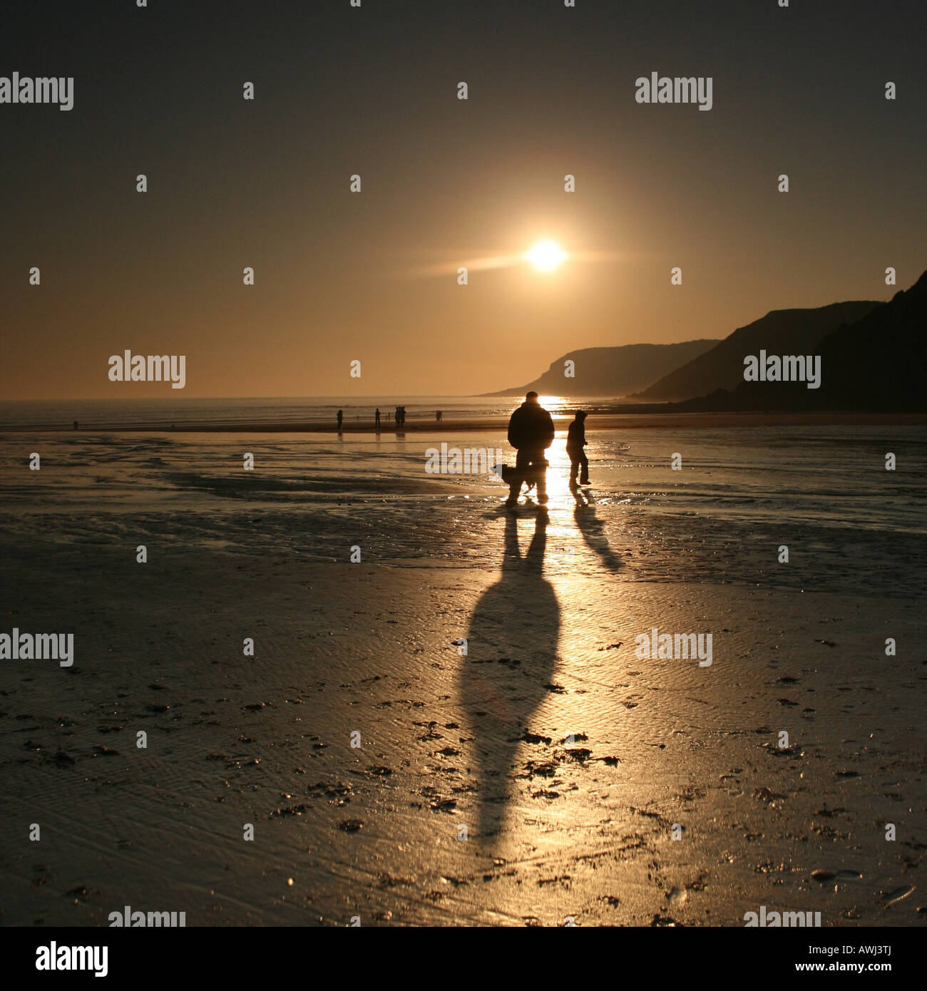 Watching the Sunset at Caswell Bay Stock Photo - Alamy