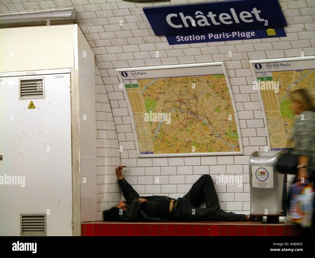 Paris Metro Chatelet station sleeping tramp on bench and passerby Stock ...