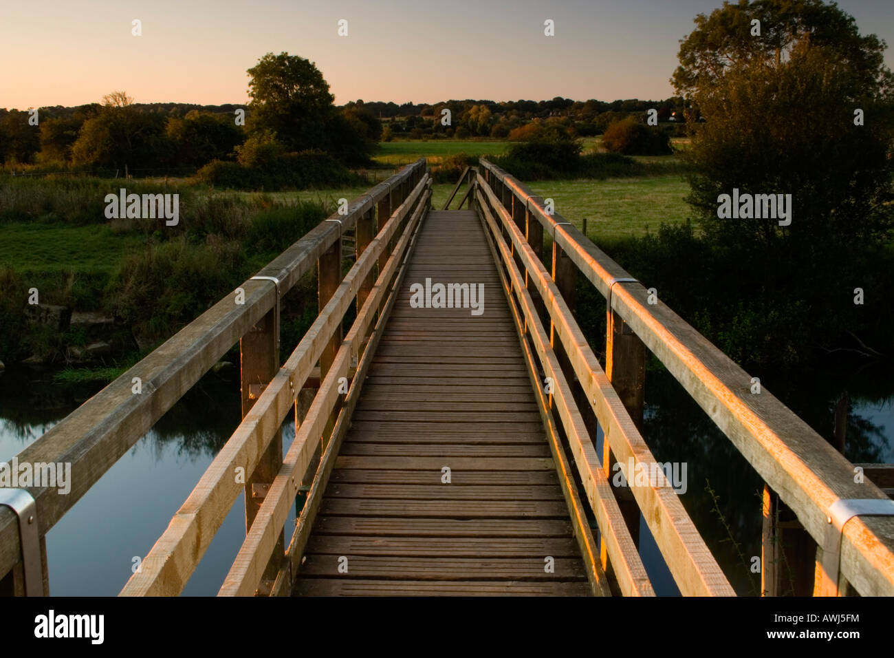 Wooden footbridge across the River Stour near Wimborne in Dorset. Known ...