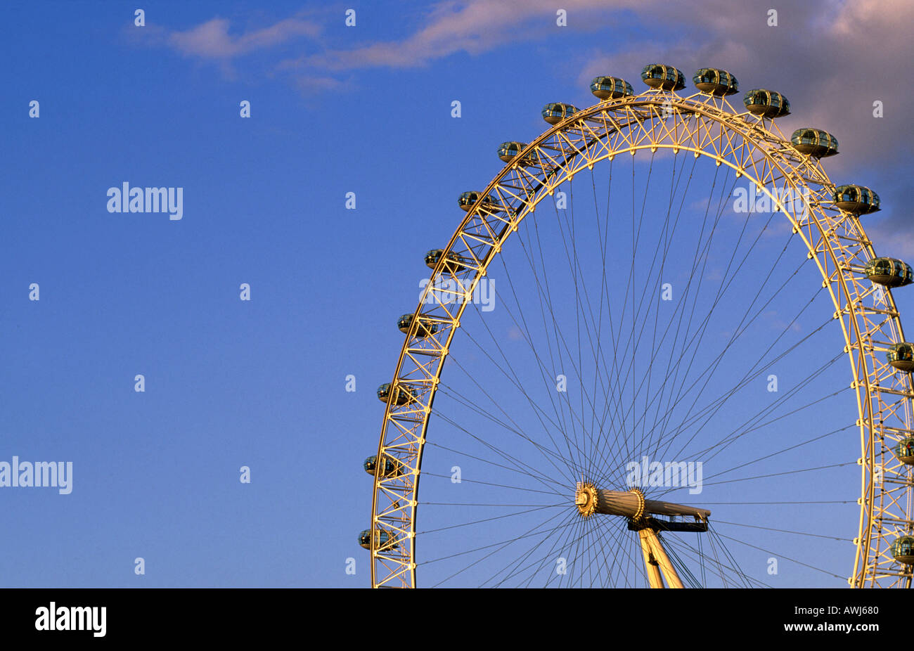 London Eye in late evening sunshine with a blue sky, Westminster ...