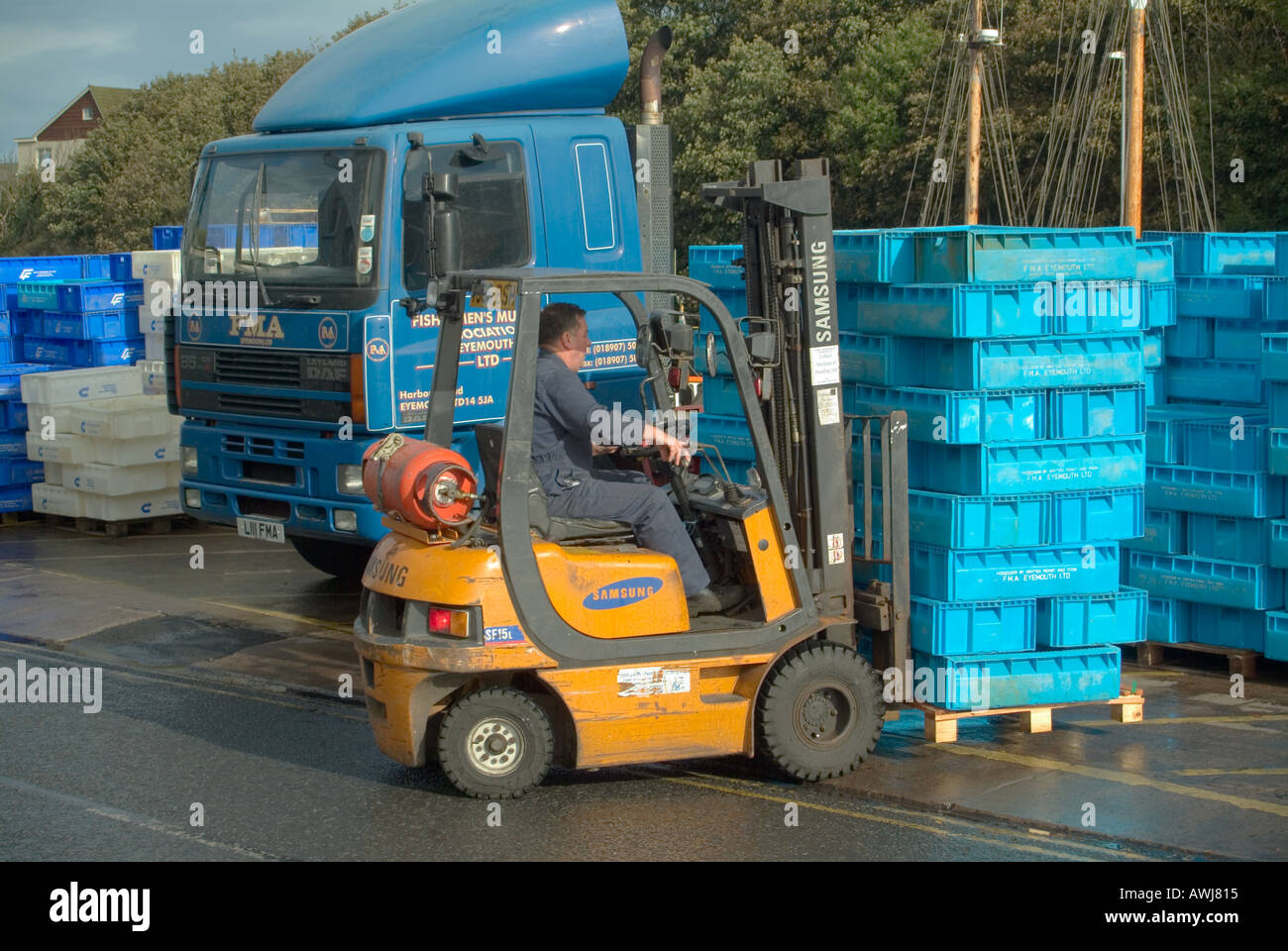Eyemouth fork lift fish boxes Stock Photo - Alamy