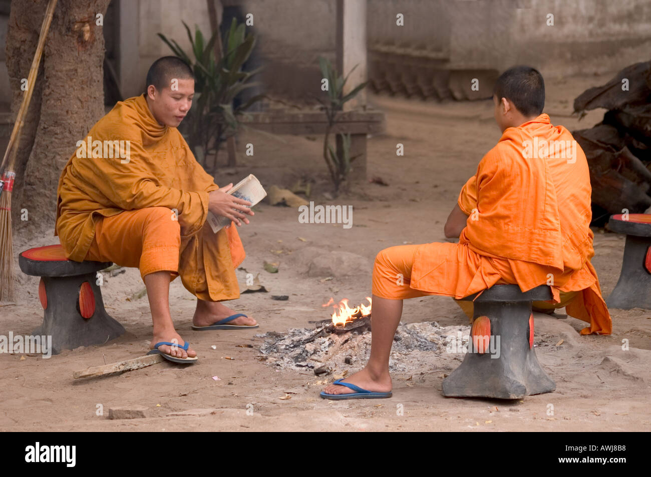 monks around fire Luang Prabang Laos Stock Photo - Alamy