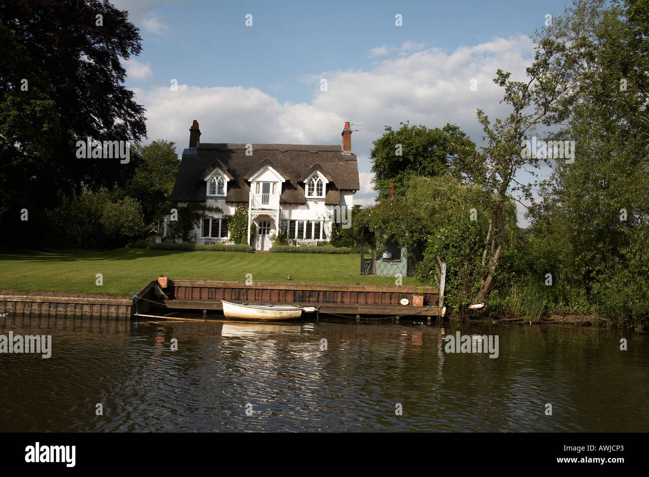 Traditional beautiful residential riverside house or home with jetty ...