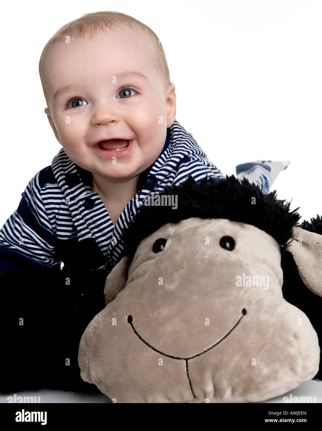 Smiling baby with soft toy Stock Photo - Alamy