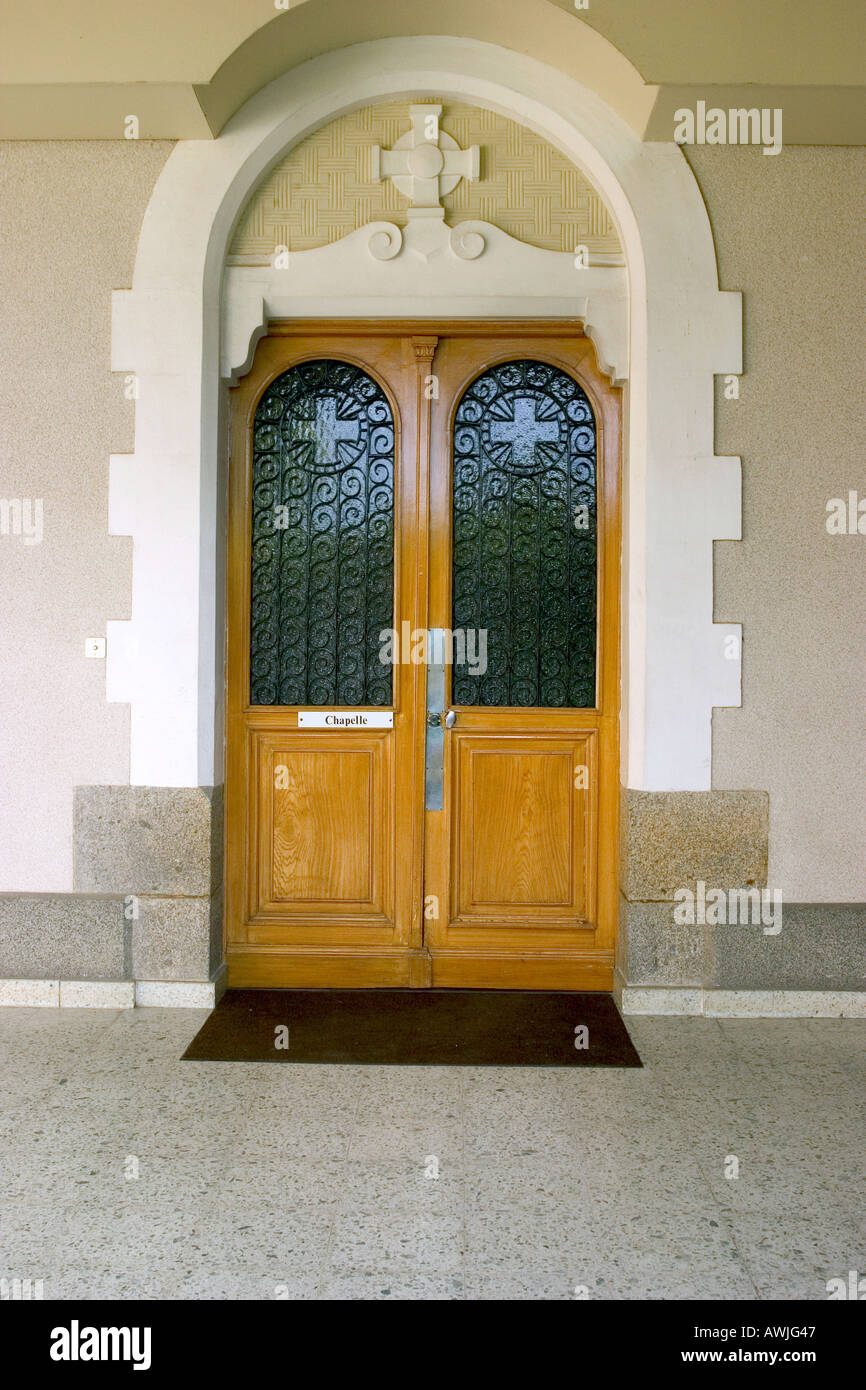 glass door of new modern church with cross with catholic religious sign ...