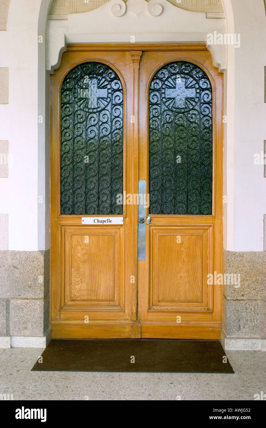 glass door of new modern church with cross with catholic religious sign ...