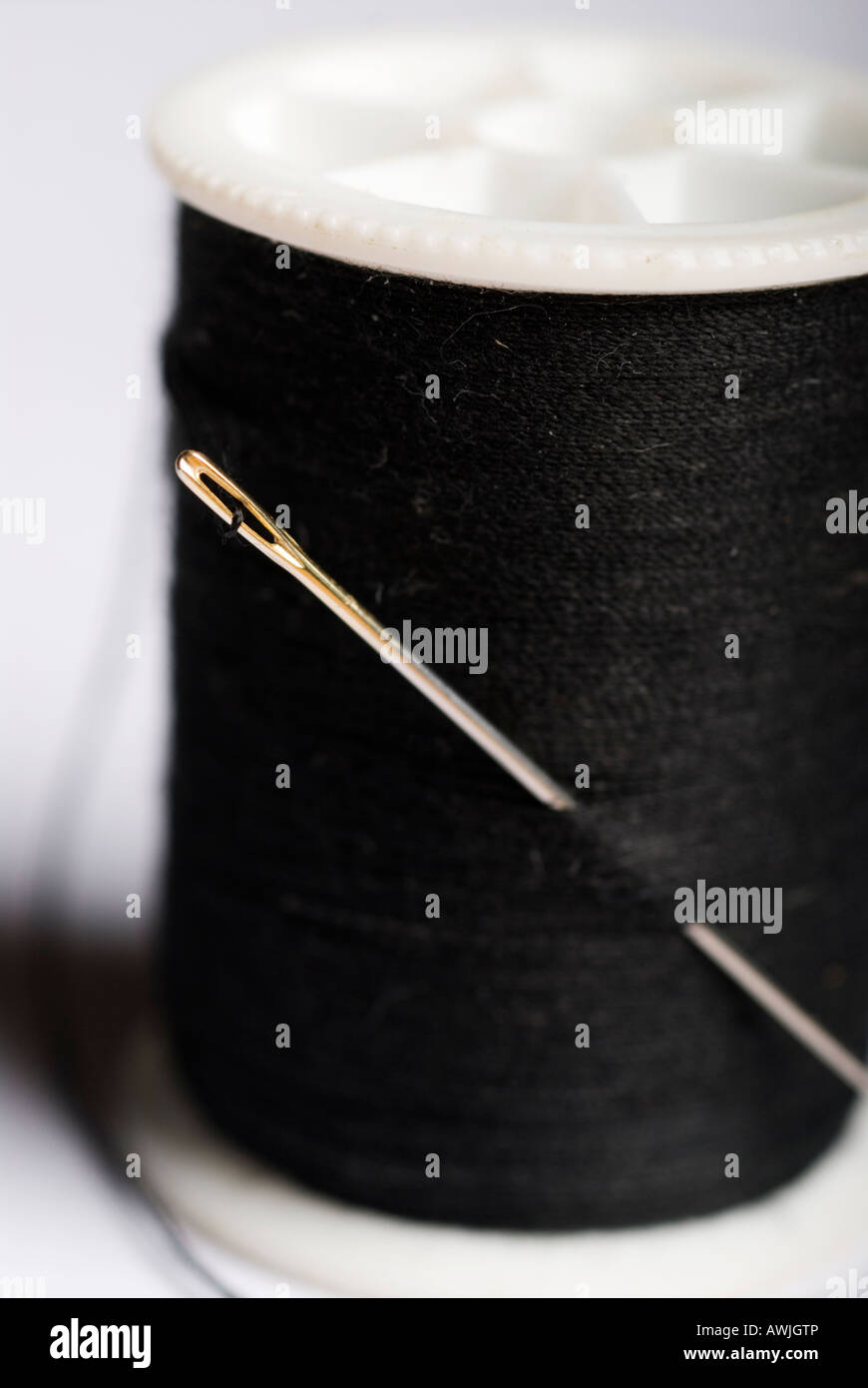 Stock photo of a threaded needle and cotton reels Stock Photo - Alamy
