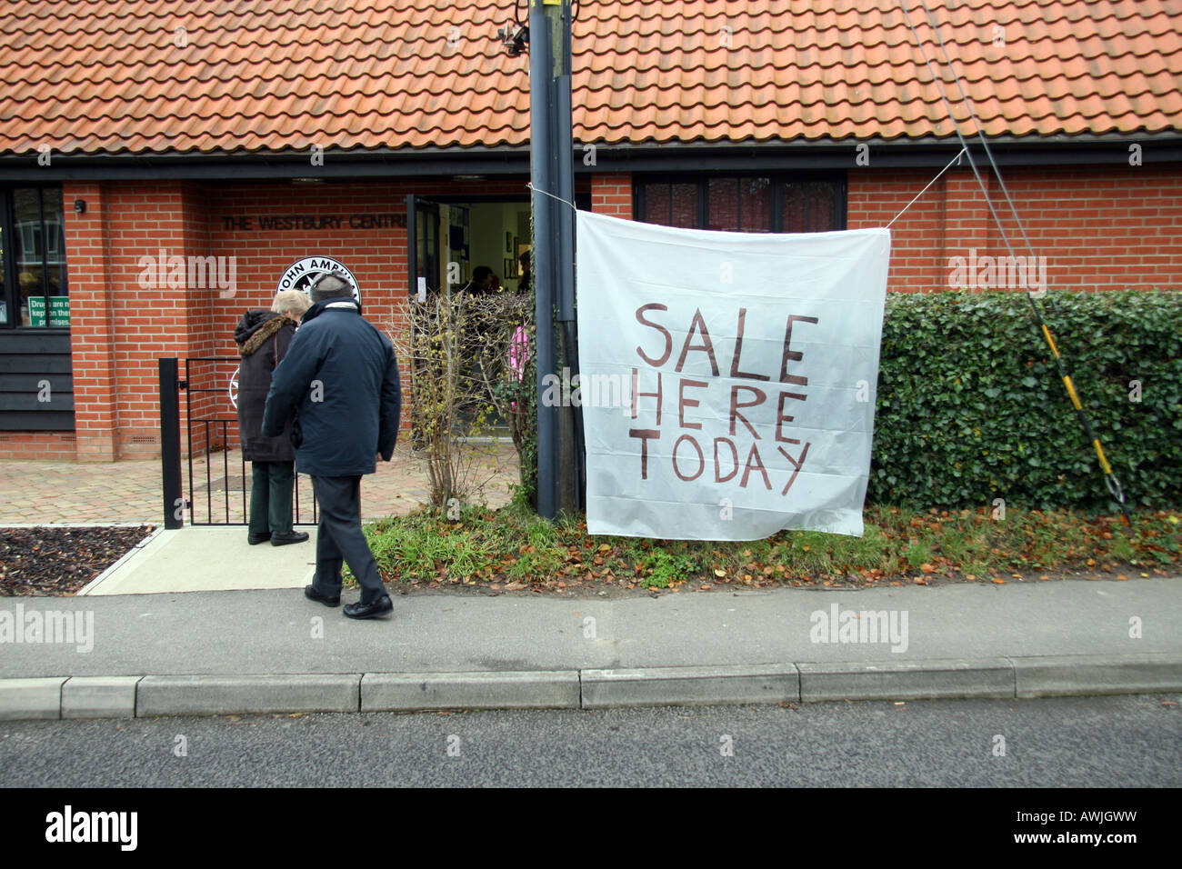 A sale at a community centre is advertised on a plastic sheet Stock ...