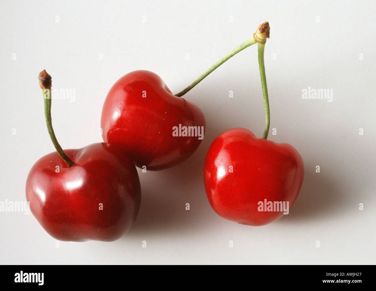 Three cherries against white background, close-up Stock Photo - Alamy