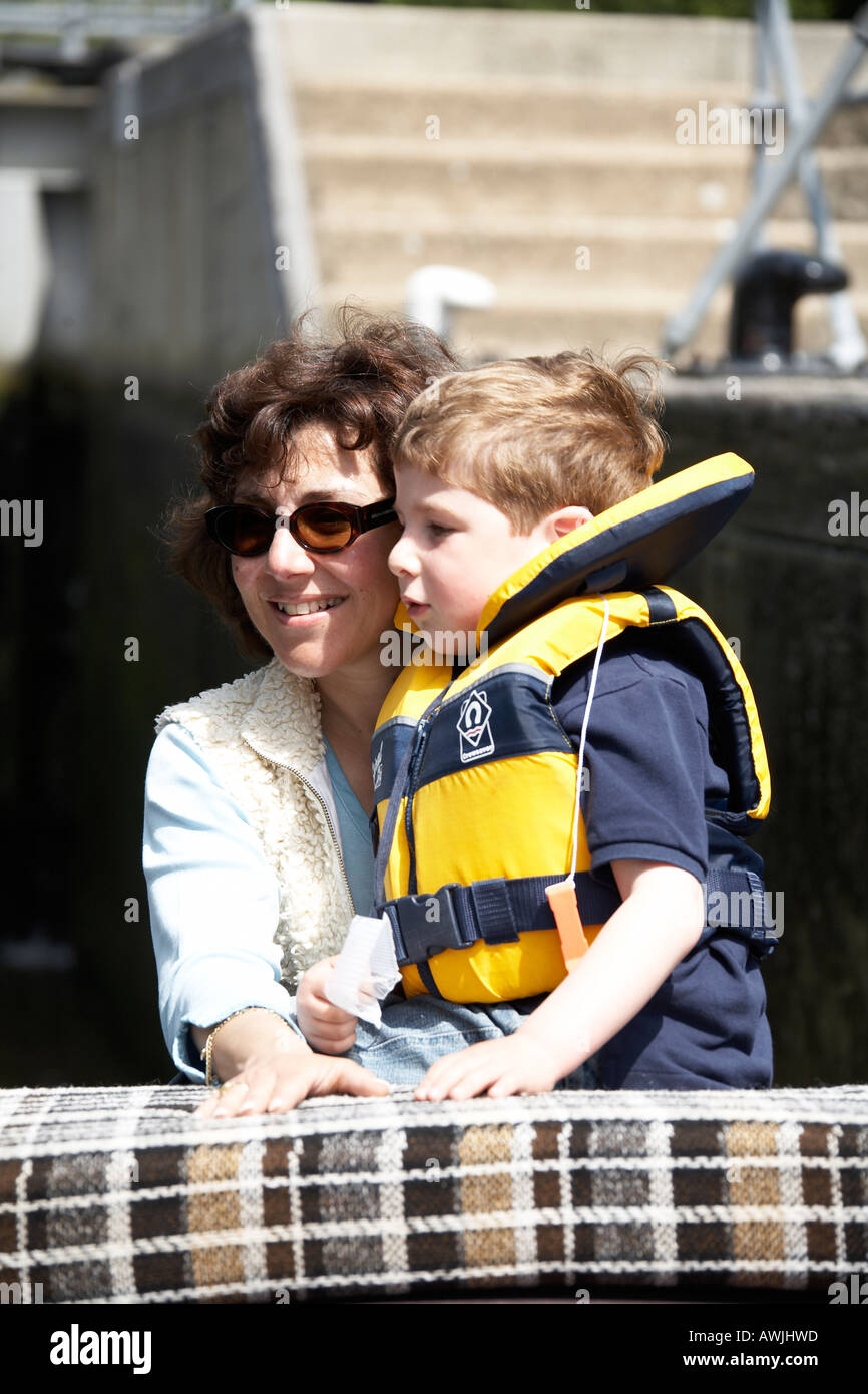 Mother and boy child on longboat passing through Mapledurham Lock near ...