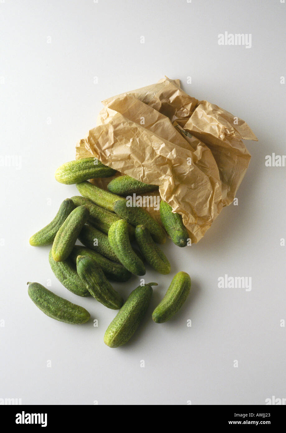 Little cucumbers spilling out of paper sack Stock Photo - Alamy