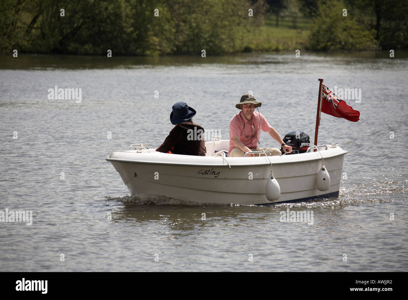 Small motorized dinghy with man and woman near Purley on Thames on ...
