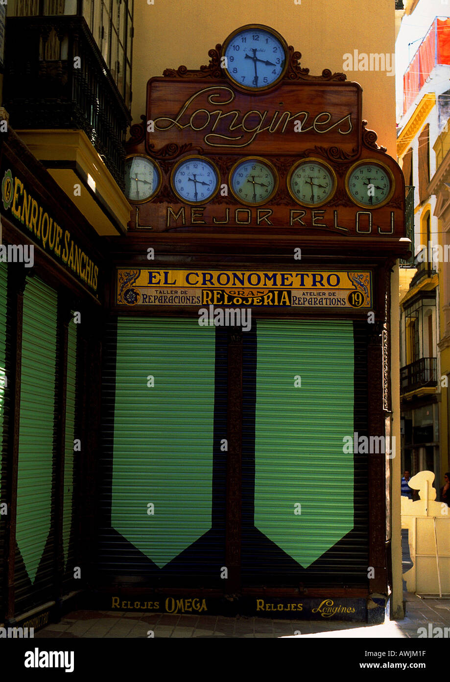 Collection of signs and clocks on street corner Stock Photo - Alamy