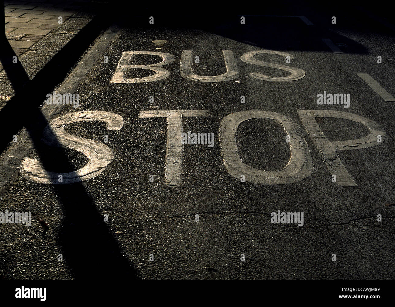 Bus Stop painted text on street Stock Photo - Alamy