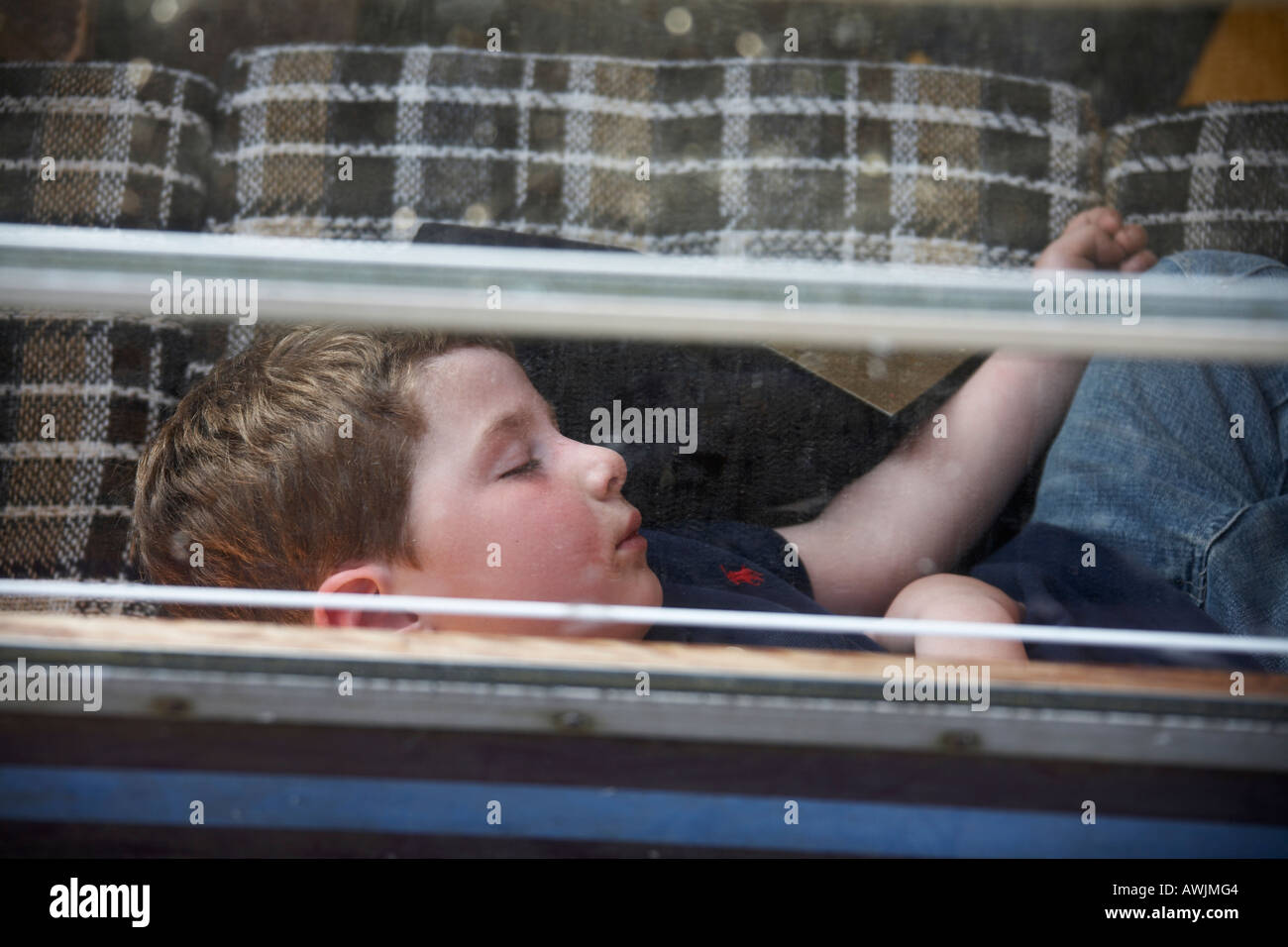 Boy child asleep inside longboat near zzz on River Thames between ...