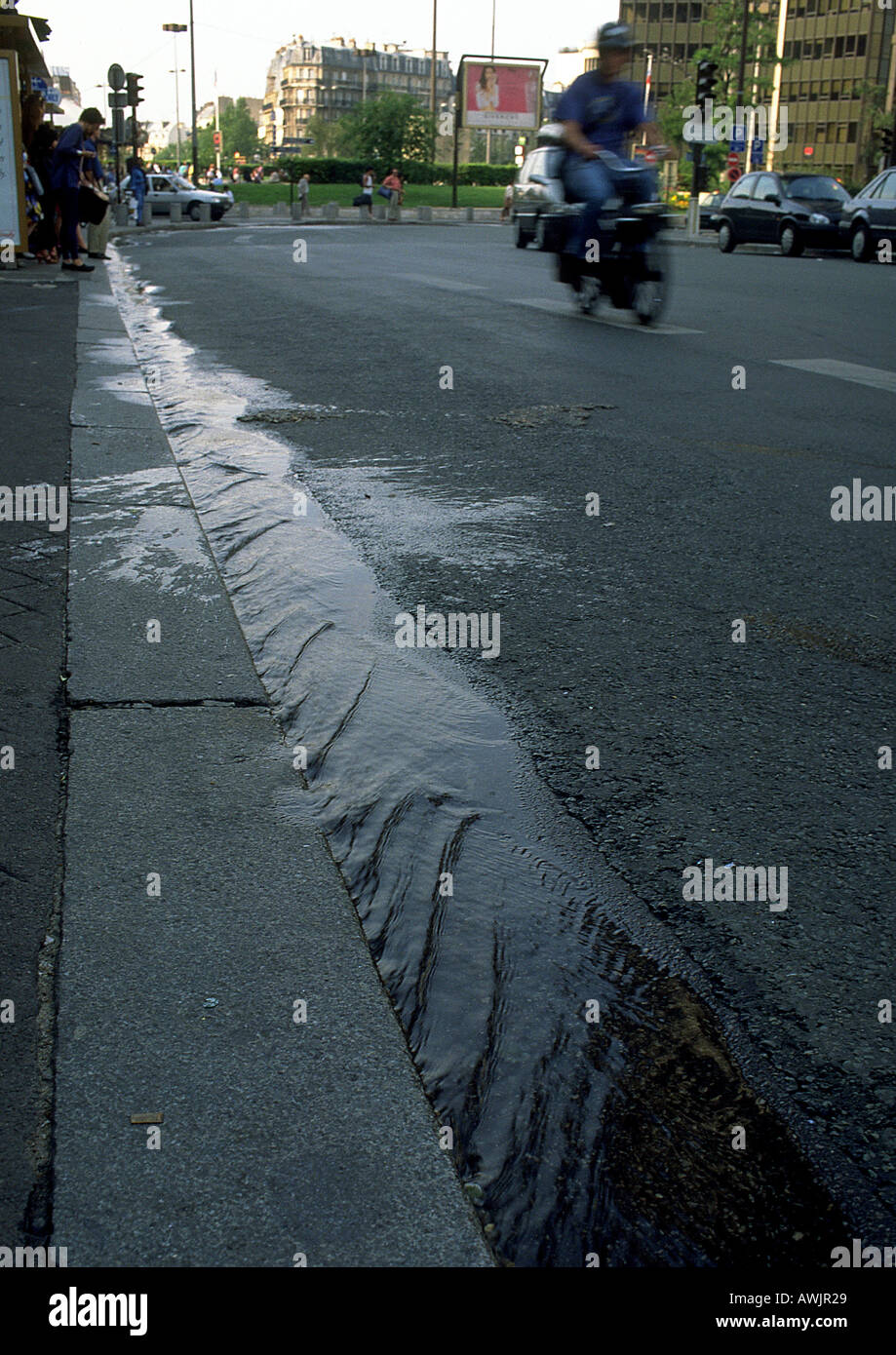 Water flowing along street gutter Stock Photo - Alamy