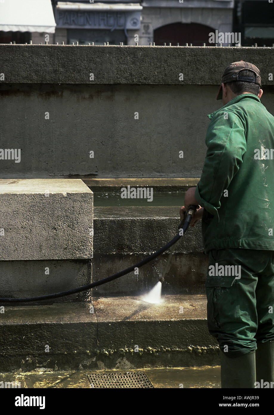 Man hosing off steps Stock Photo - Alamy