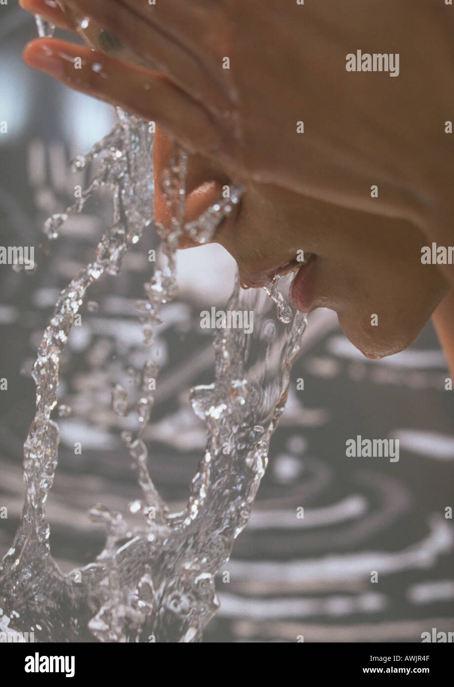 Person splashing water on face, close-up Stock Photo - Alamy