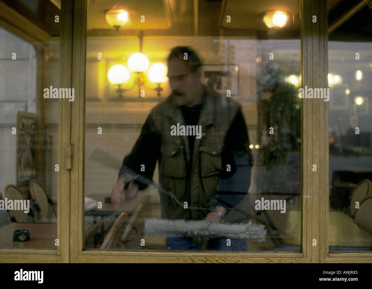 Window washer washing windows inside cafe Stock Photo - Alamy