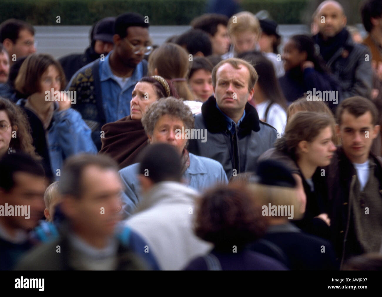 Crowd, focus on man in middle ground Stock Photo - Alamy