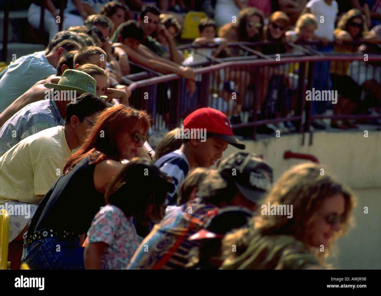 Crowd leaning over railing, looking down Stock Photo - Alamy