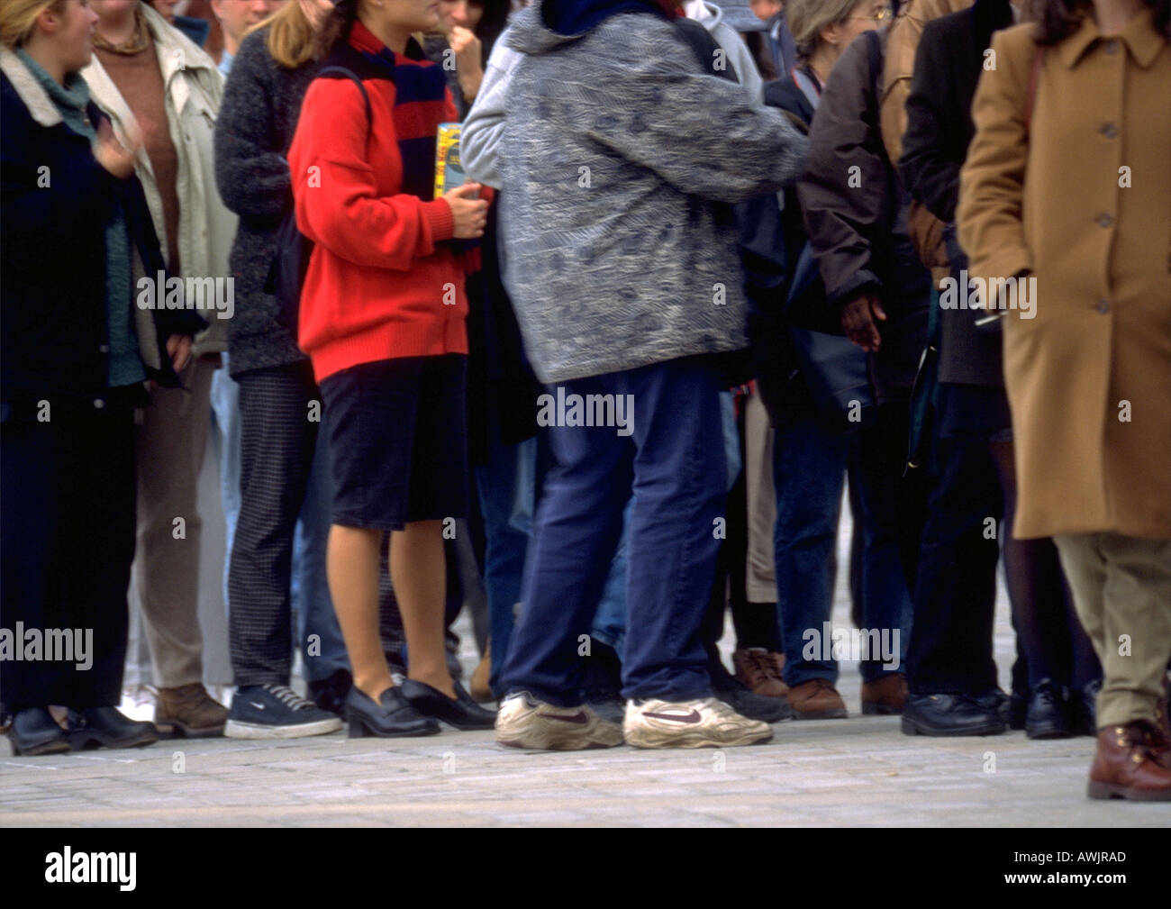 Crowd of people standing in line on sidewalk, cropped view Stock Photo ...