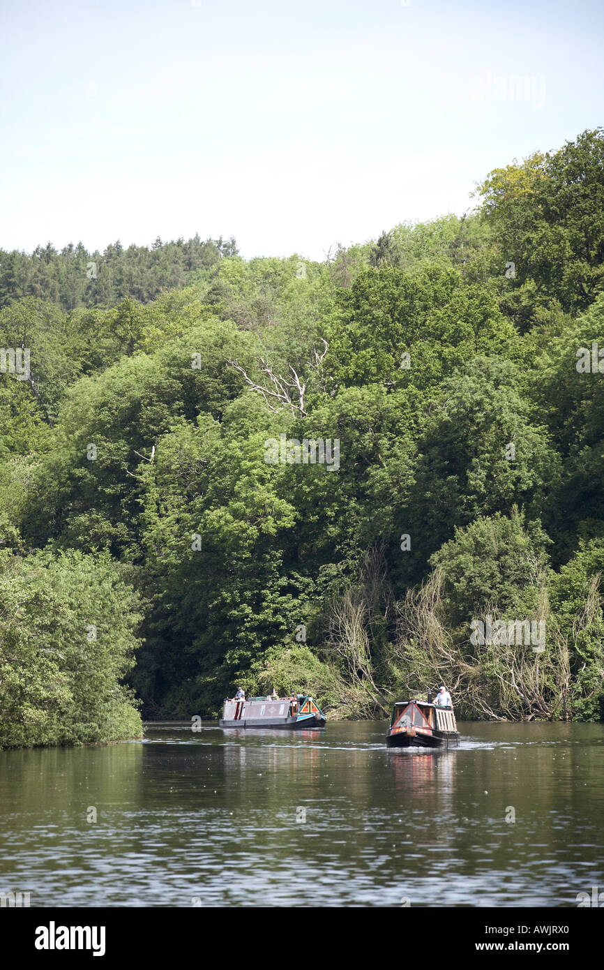 Longboats on river with trees in background near Henley on Thames on ...
