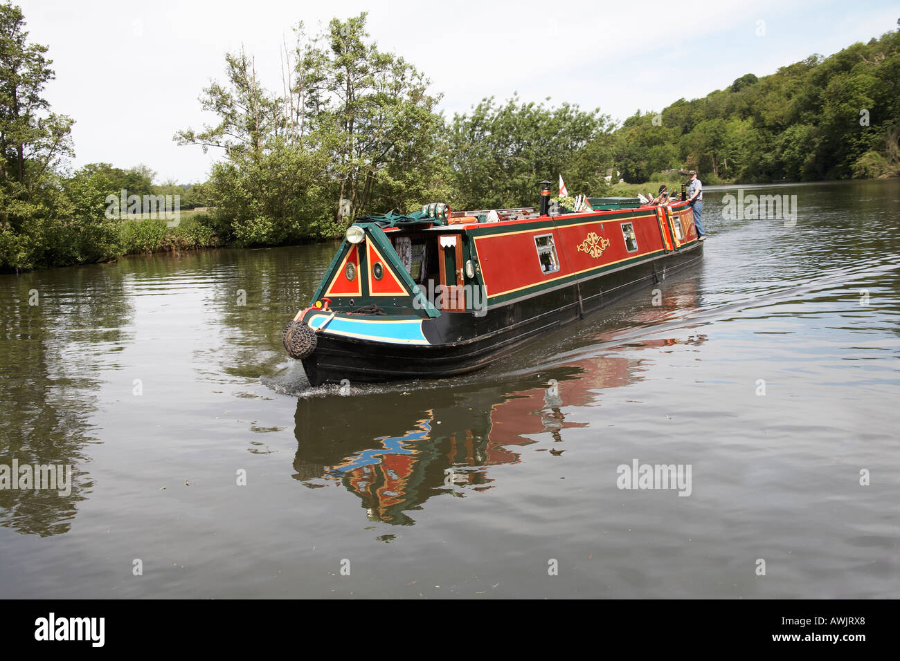 Man on red and green longboat near Henley on Thames on River Thames ...