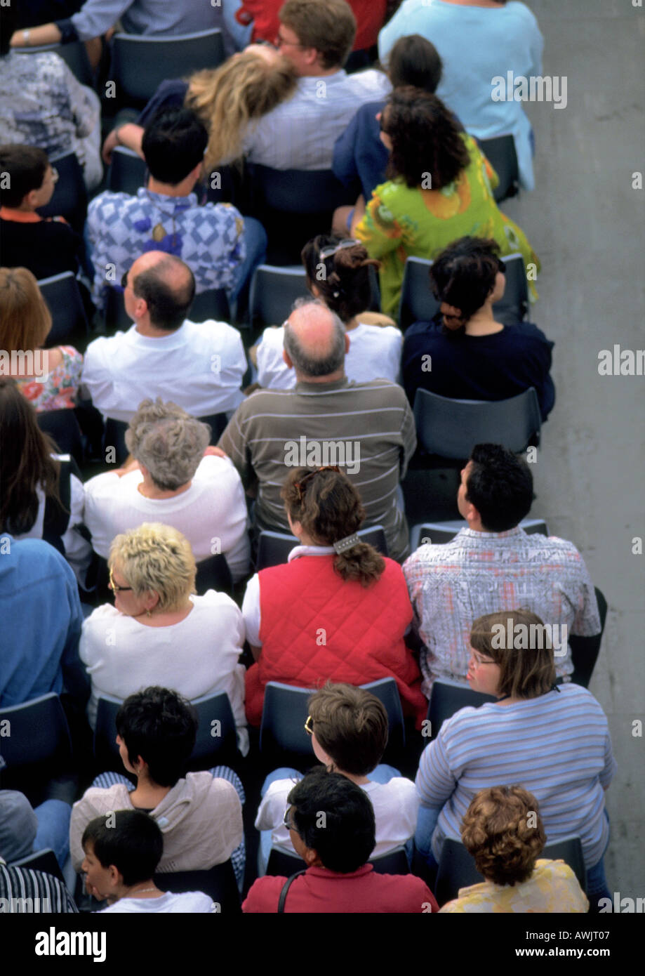 Crowd sitting in chairs, high angle rear view Stock Photo - Alamy