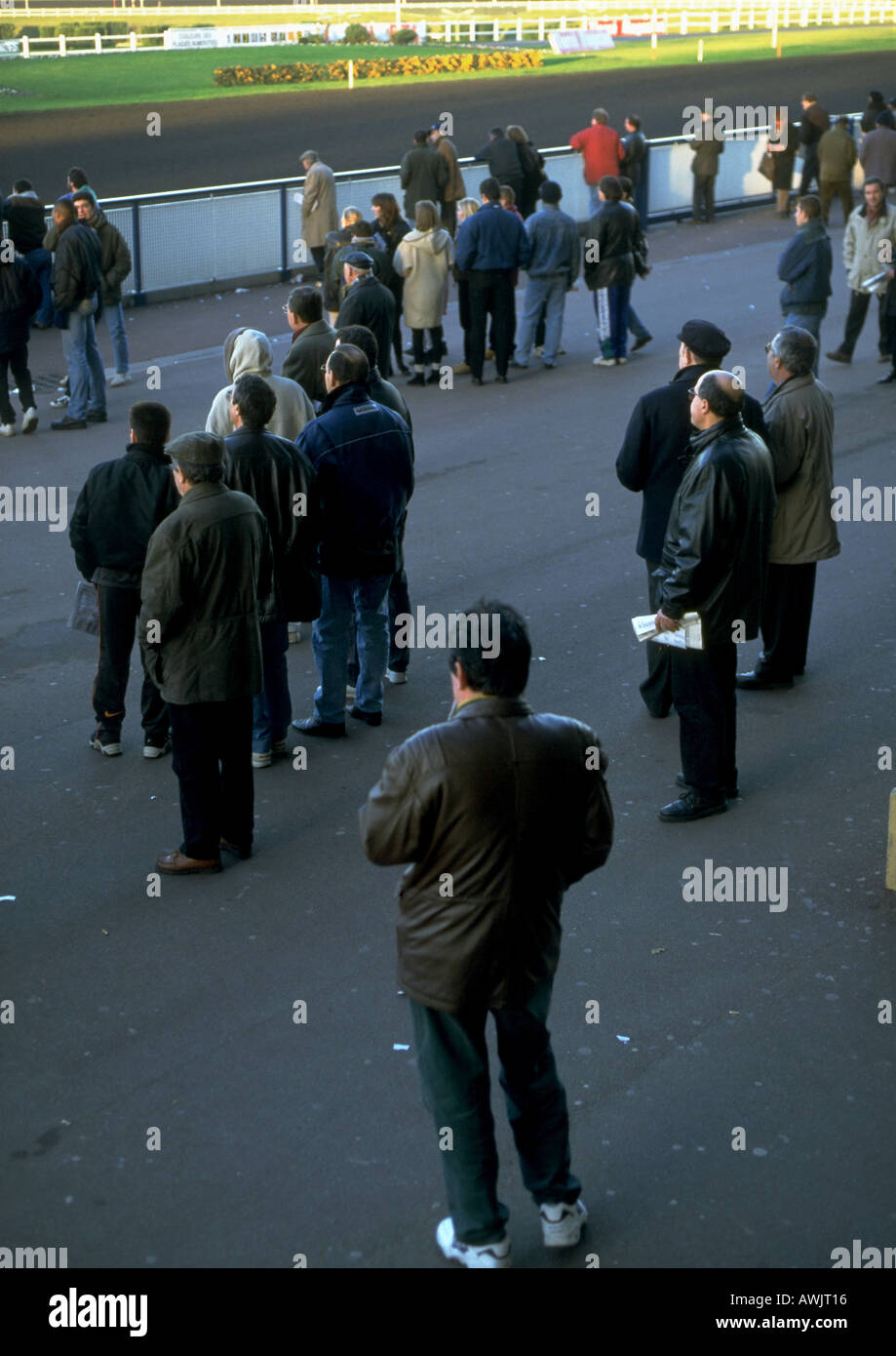 Groups of people looking toward racetrack Stock Photo - Alamy