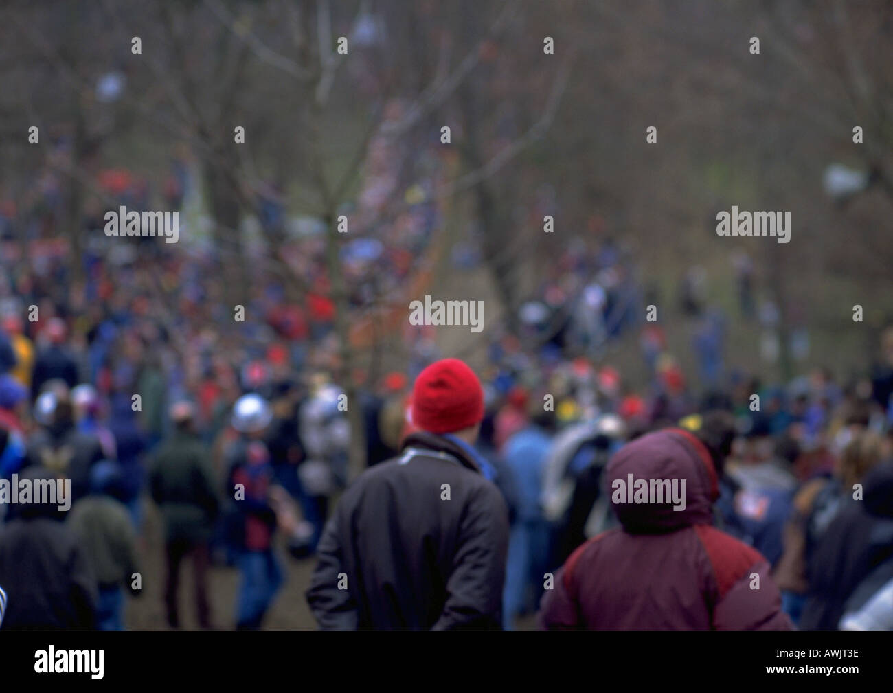 Crowd dressed for cold weather in park, blurred Stock Photo - Alamy