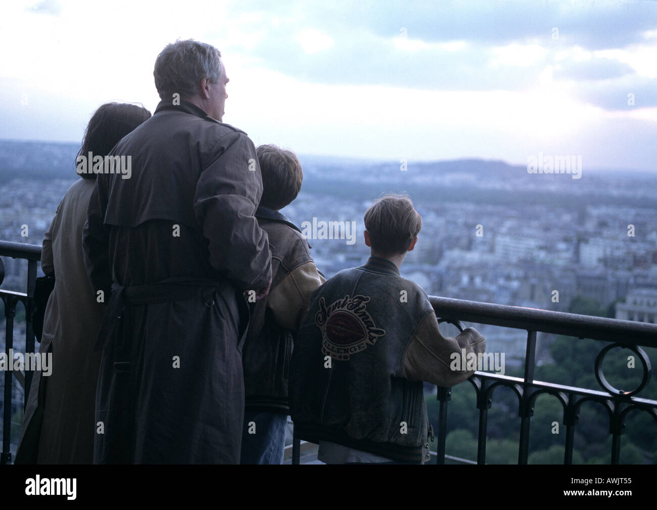 Group of people standing by rail overlooking city Stock Photo - Alamy