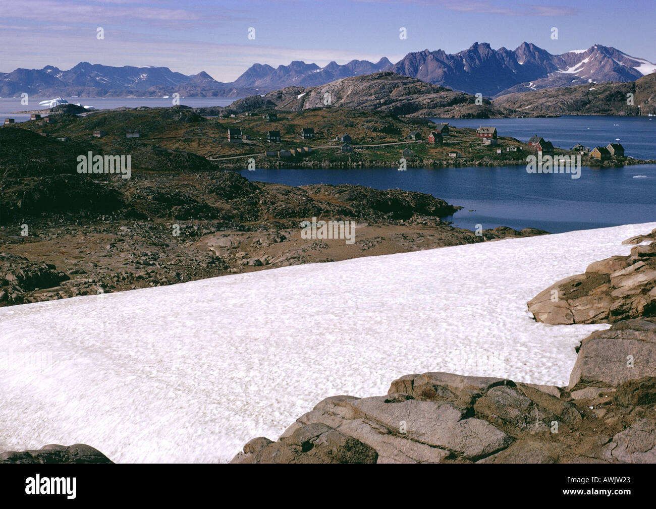Greenland, village with mountain range in background Stock Photo - Alamy