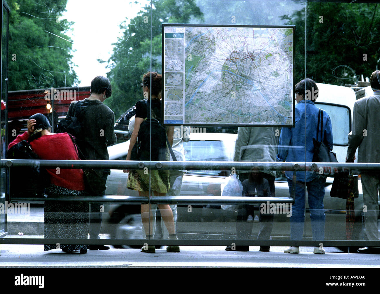 People standing at bus stop, rear view Stock Photo - Alamy