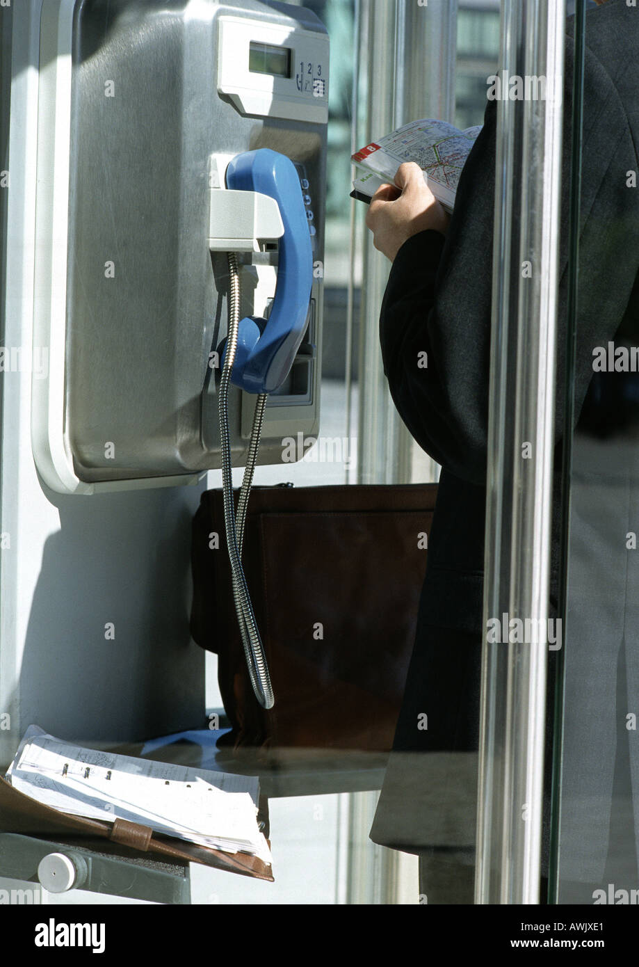 Person using pay phone Stock Photo - Alamy