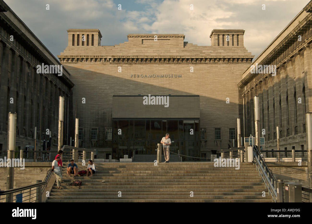 Watchman locking the gate at Pergamon Museum. Group of tourists ...