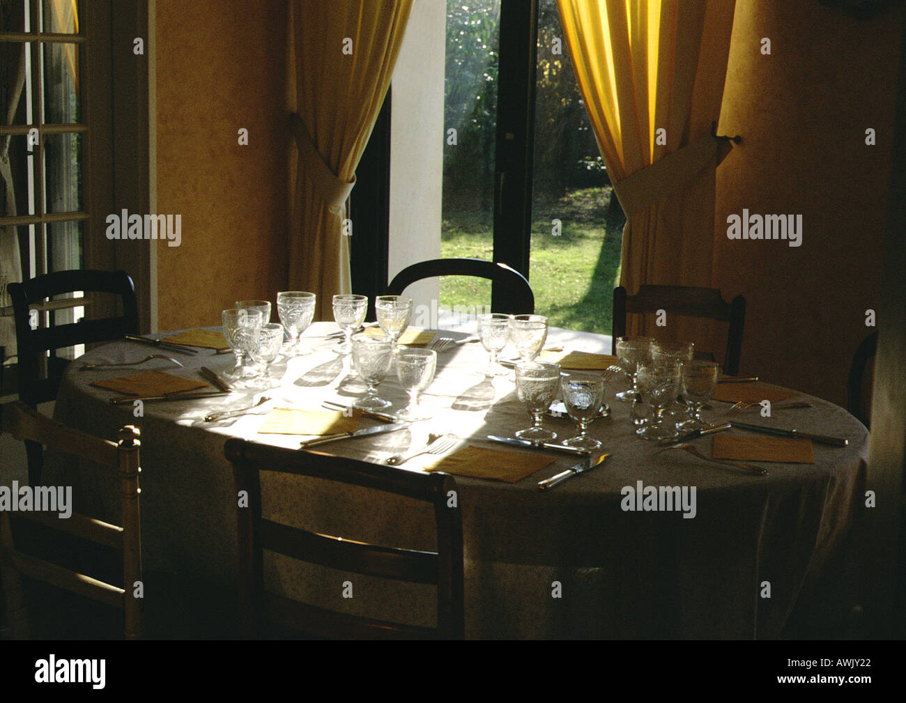 Set dinner table with light coming in from window Stock Photo - Alamy