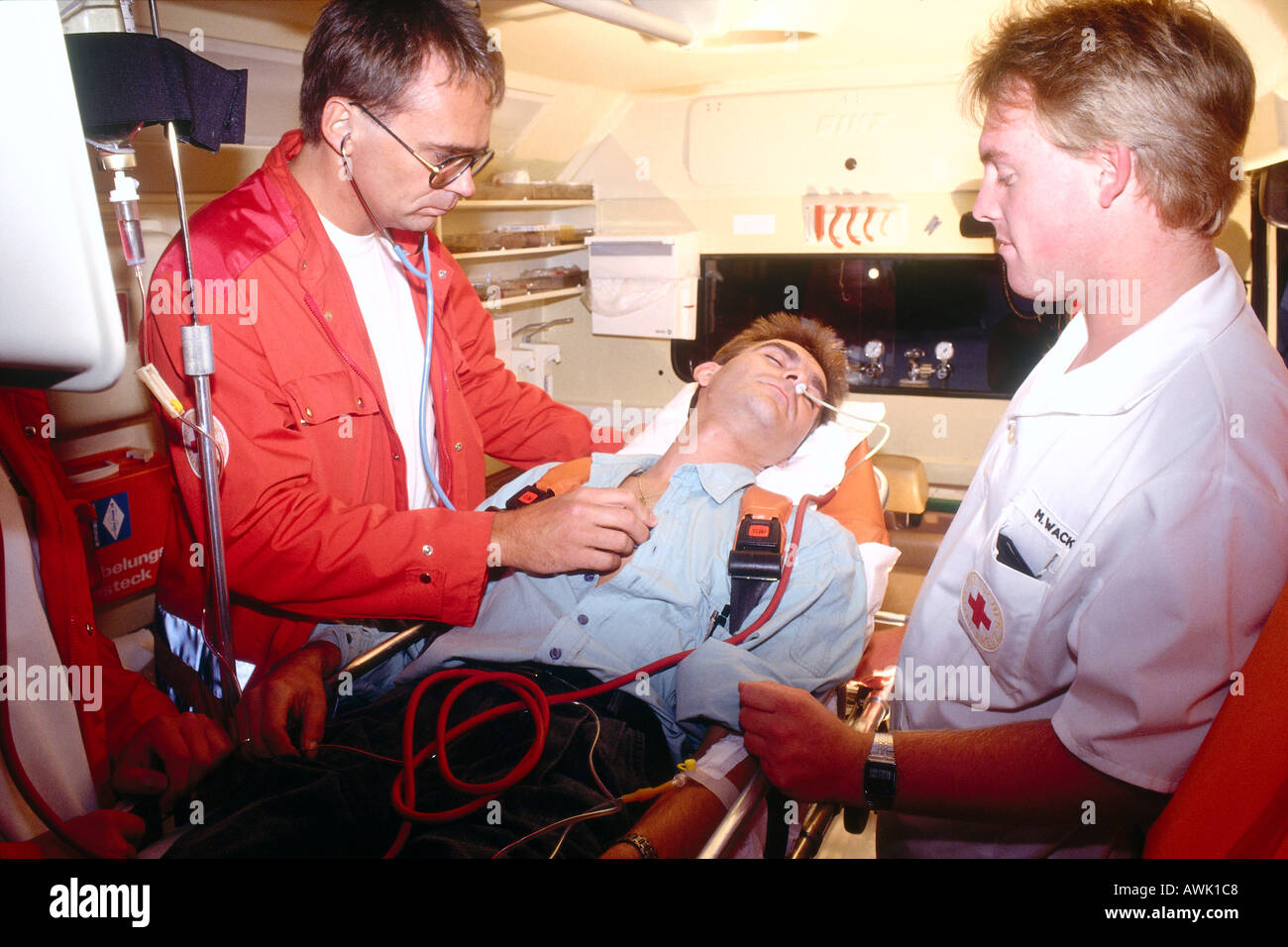 First aid doctor helping patient on stretcher Stock Photo - Alamy