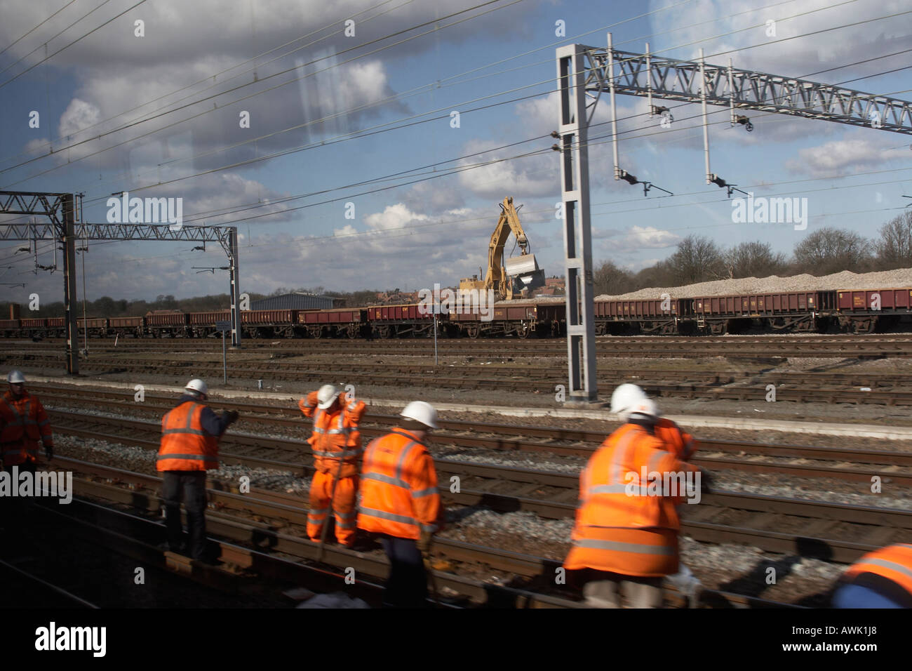 Electrified railway lines goods train and maintenance repair workers on ...