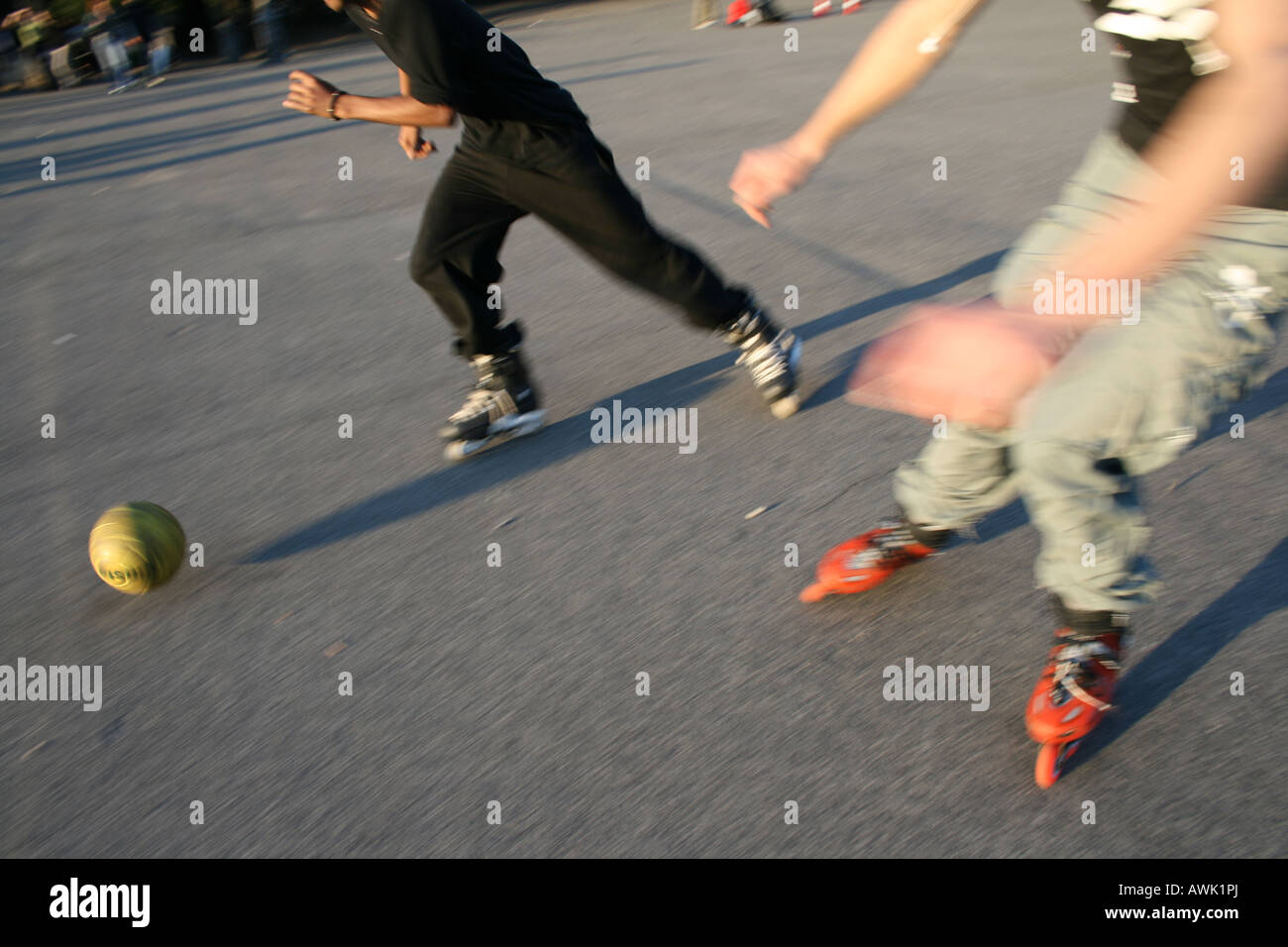 rollerblader soccer players chasing ball Stock Photo - Alamy