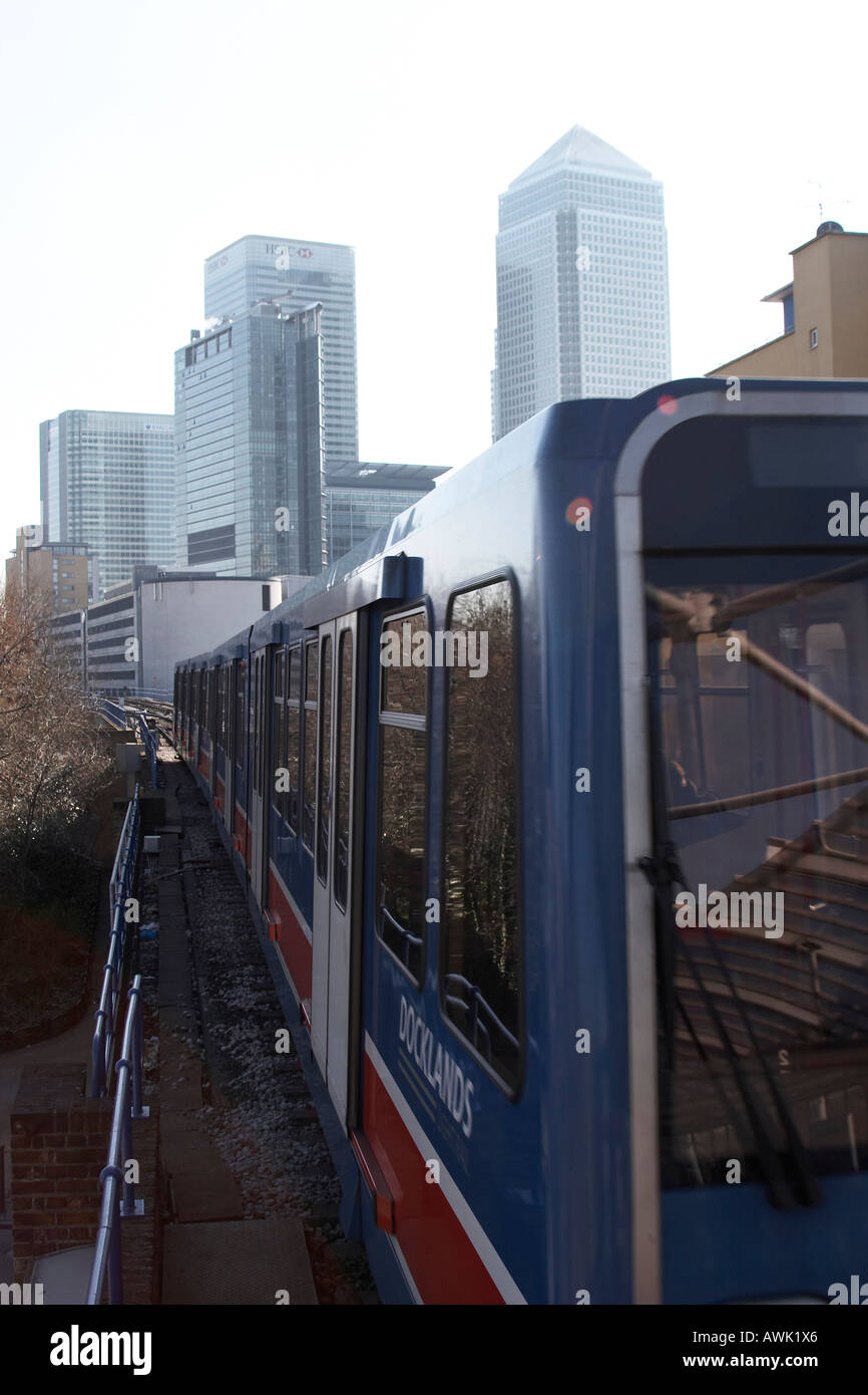 DLR Docklands Light Railway train with tall skyscraper office buildings ...