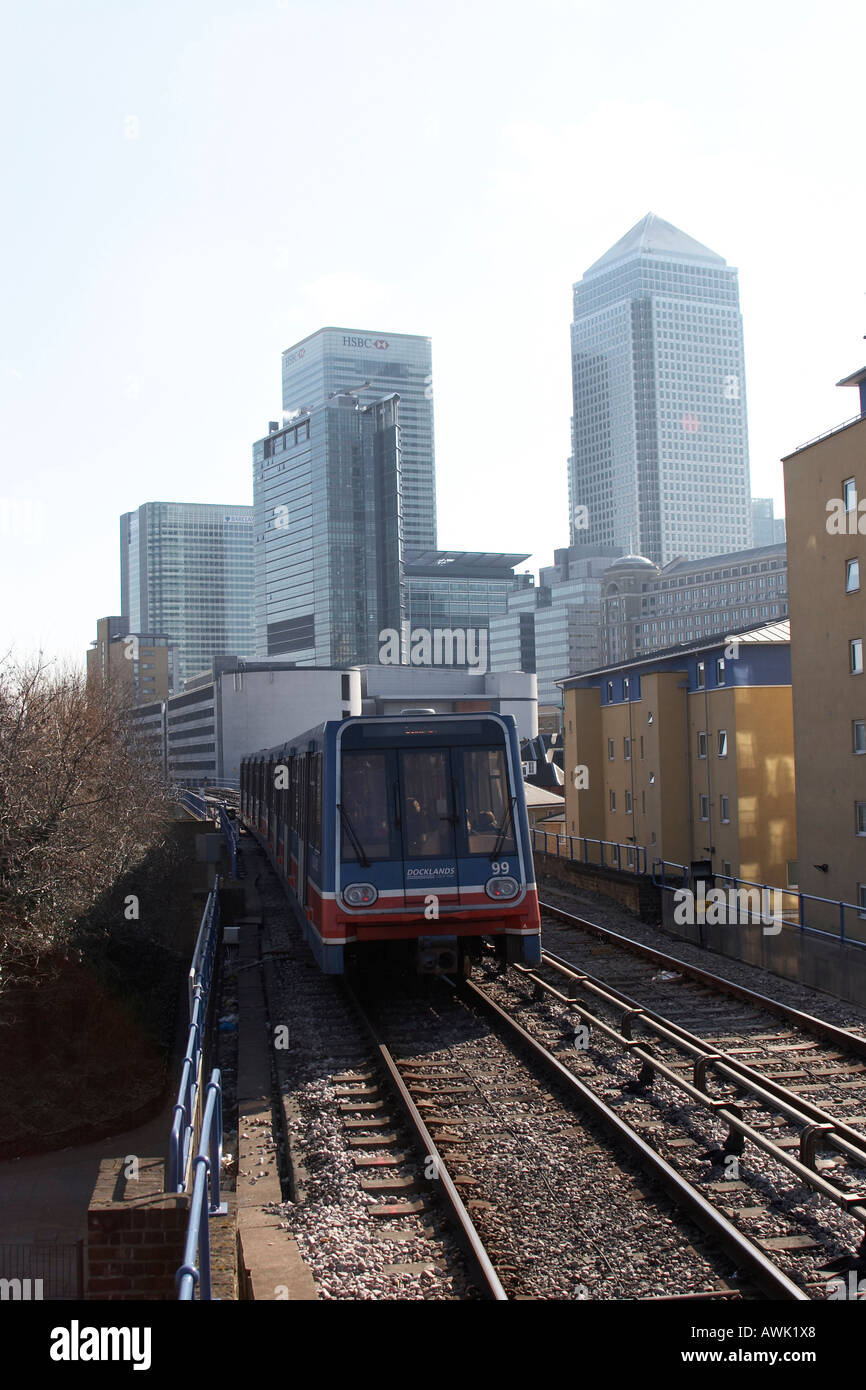 DLR Docklands Light Railway train with tall skyscraper office buildings ...