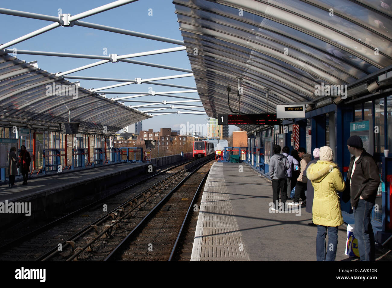 Westferry station and passengers with DLR Docklands Light Railway train ...