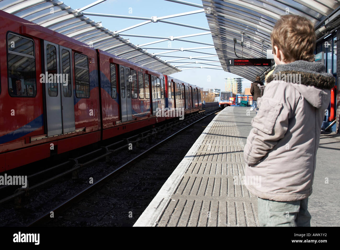 Westferry station young boy child on platform with DLR Docklands Light ...
