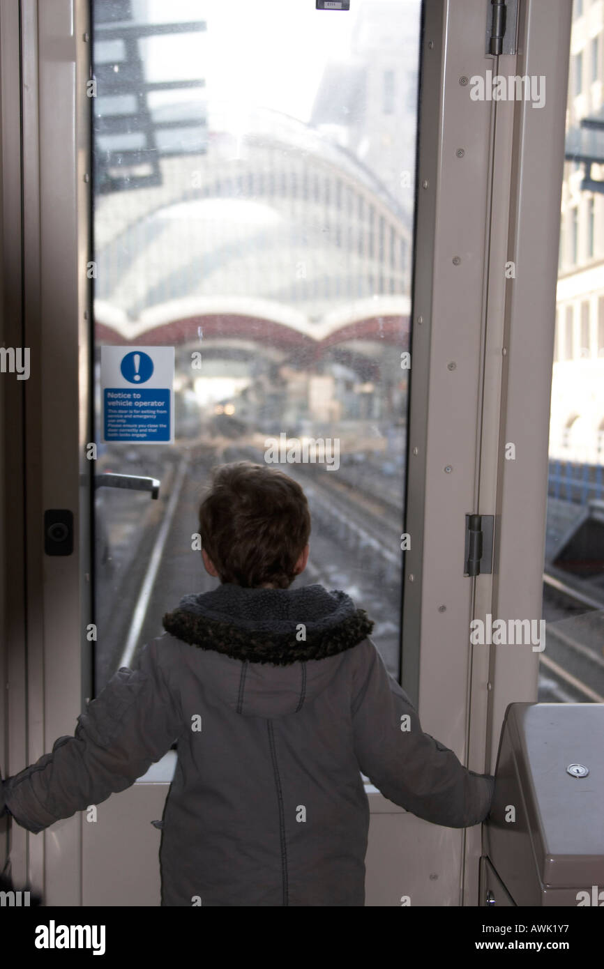 Young boy child looking out of DLR Docklands Light Railway train at ...