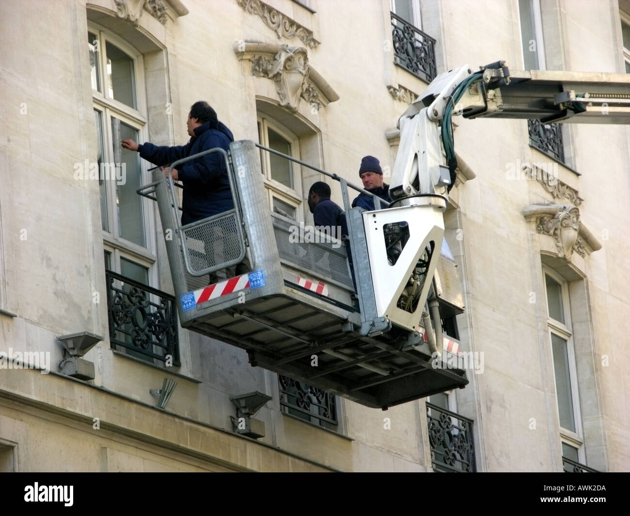 france paris window cleaners on elevator platform working on office or ...