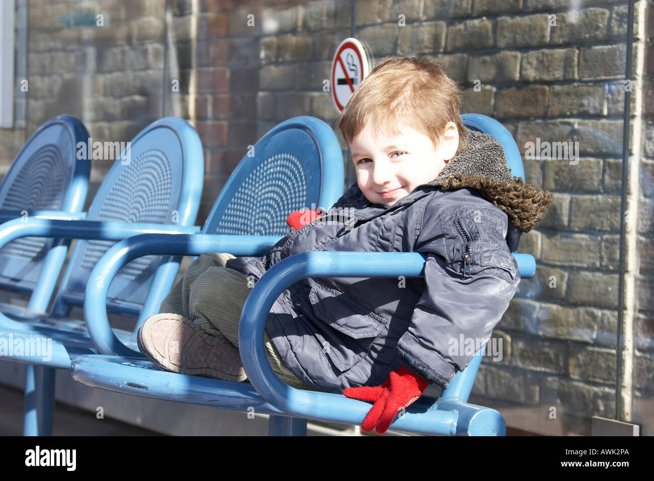 Young boy with gloves in winter on DLR Docklands Light Railway platform ...