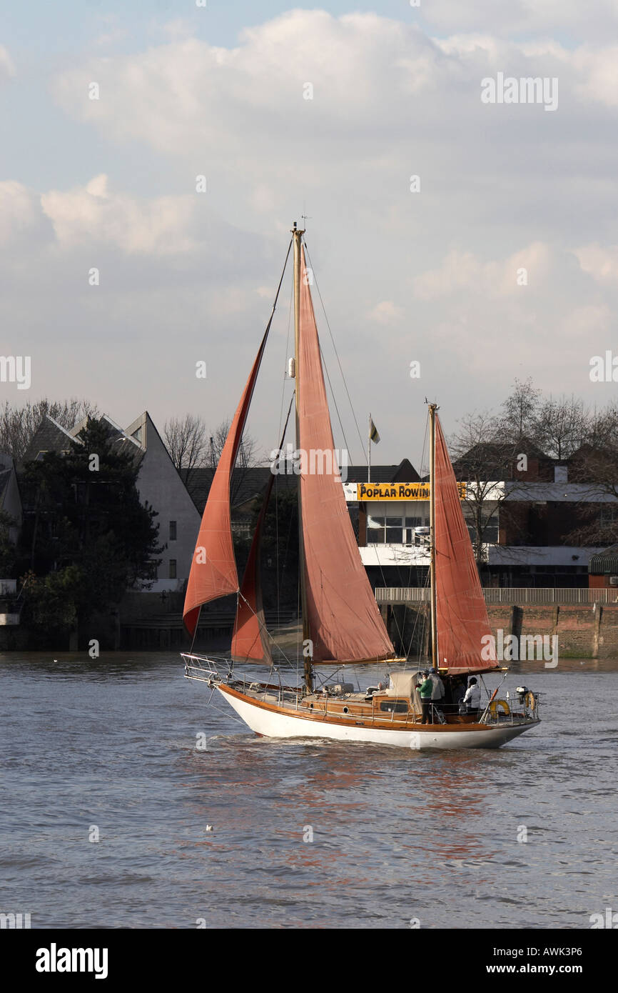 Traditional wooden sailing boat with red sails on River Thames near ...