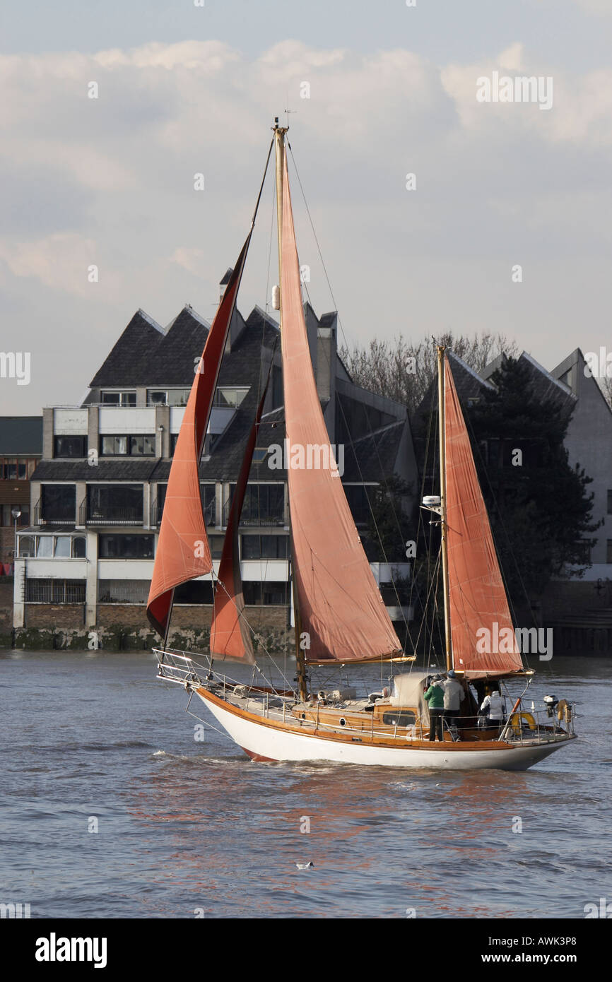 Traditional wooden sailing boat with red sails on River Thames near ...