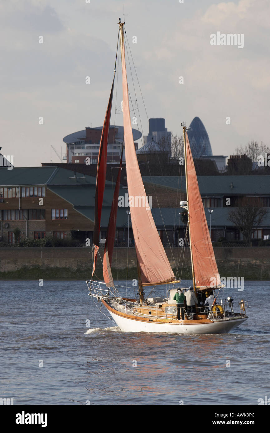 Traditional wooden sailing boat with red sails on River Thames near ...